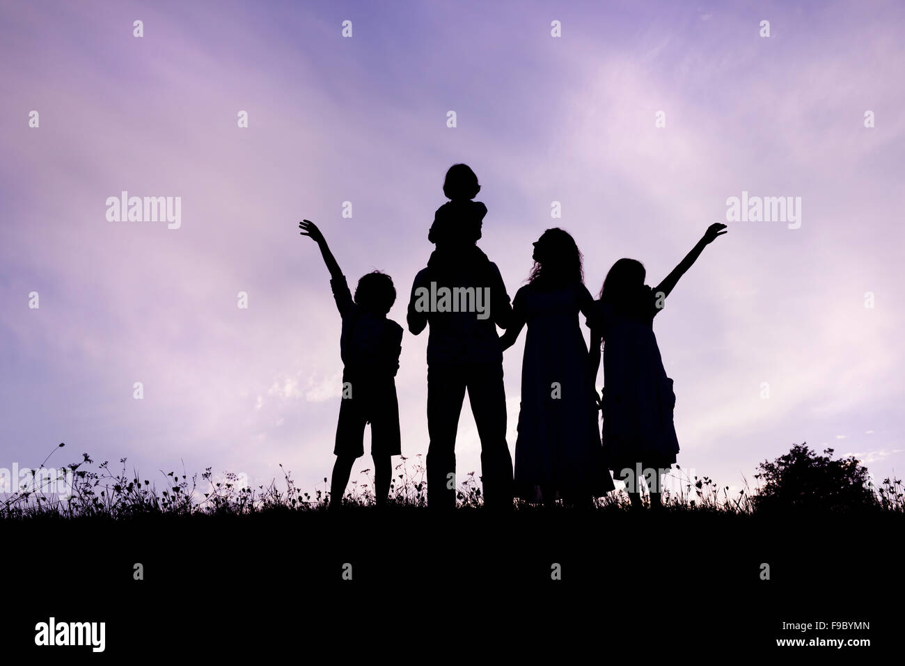 Silhouettes of happy parents having fun with their children Stock Photo ...