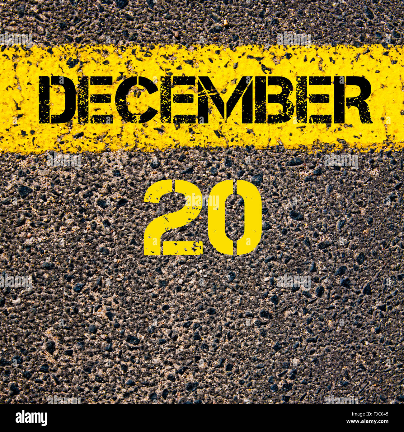 20 December calendar day written over road marking yellow paint line ...
