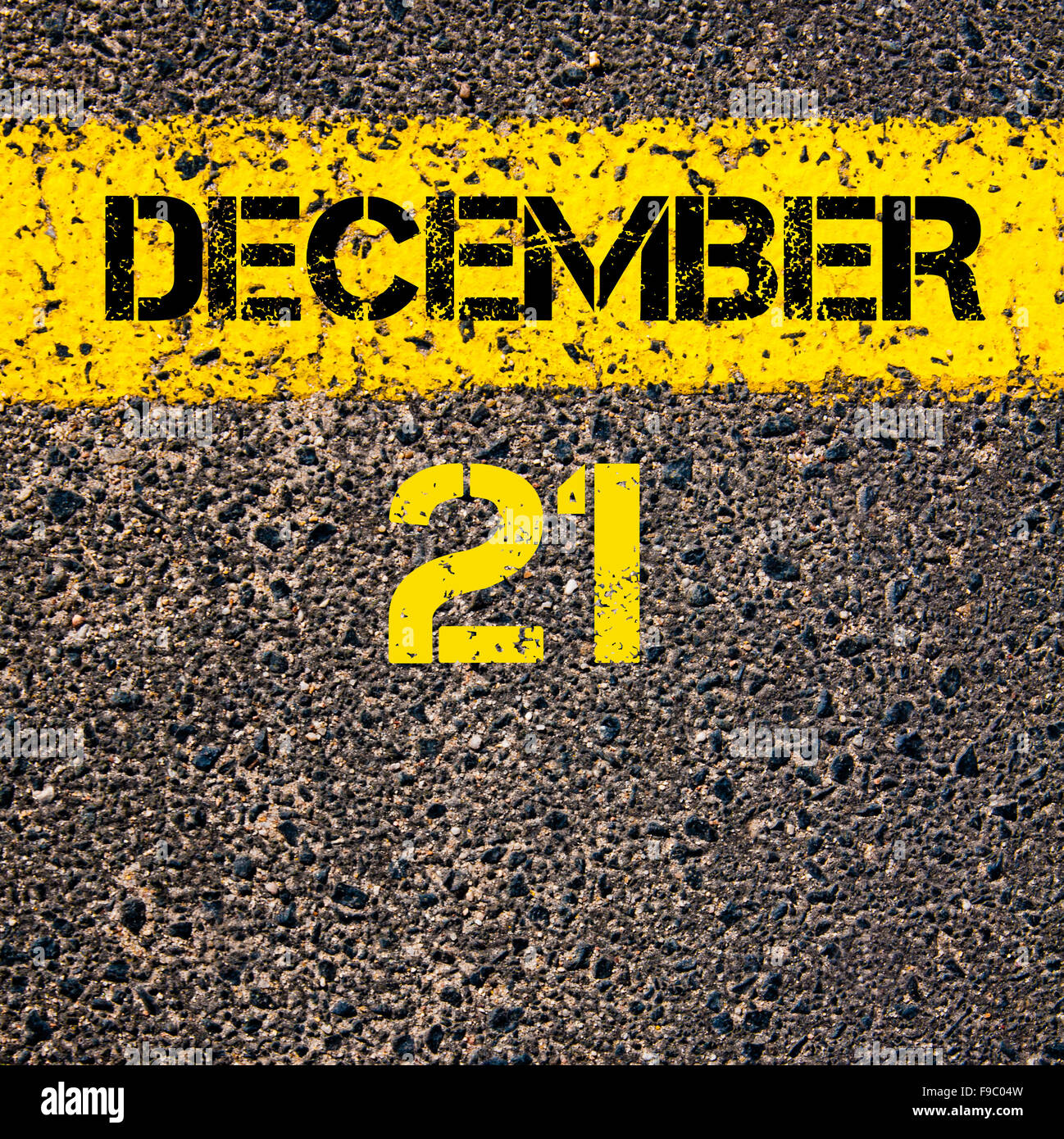 21 December calendar day written over road marking yellow paint line ...