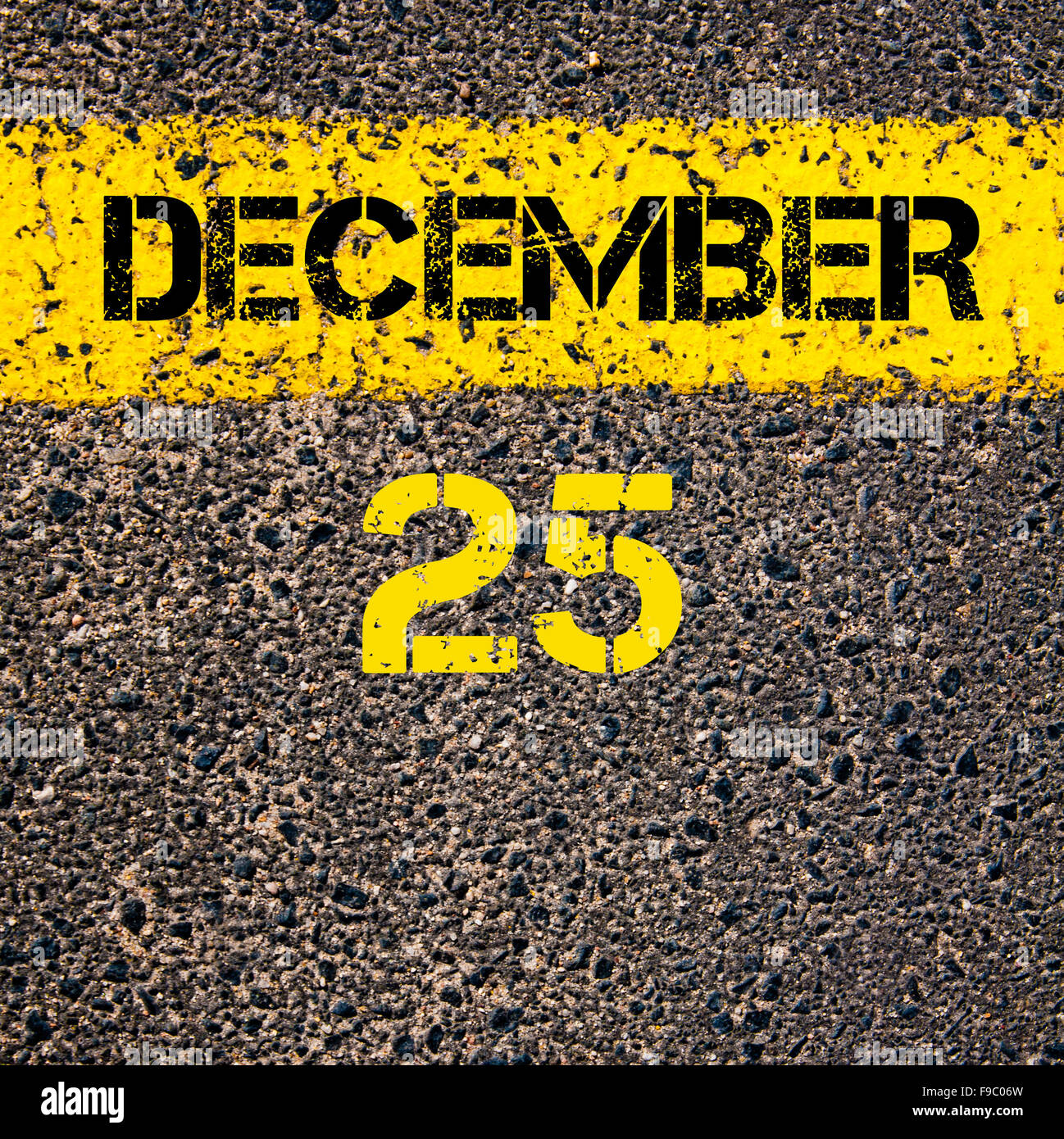 25 December calendar day written over road marking yellow paint line ...