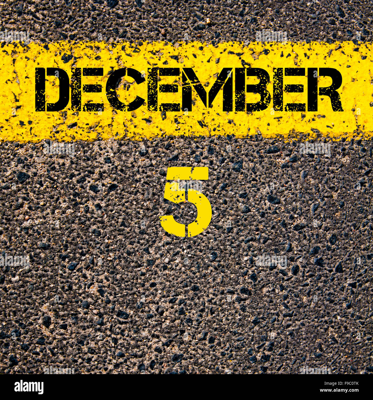 5 December calendar day written over road marking yellow paint line ...