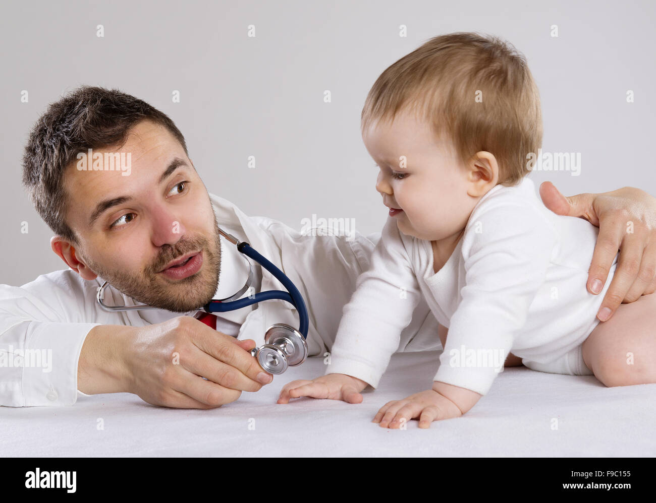 Pediatrician doctor is playing with little baby boy Stock Photo - Alamy