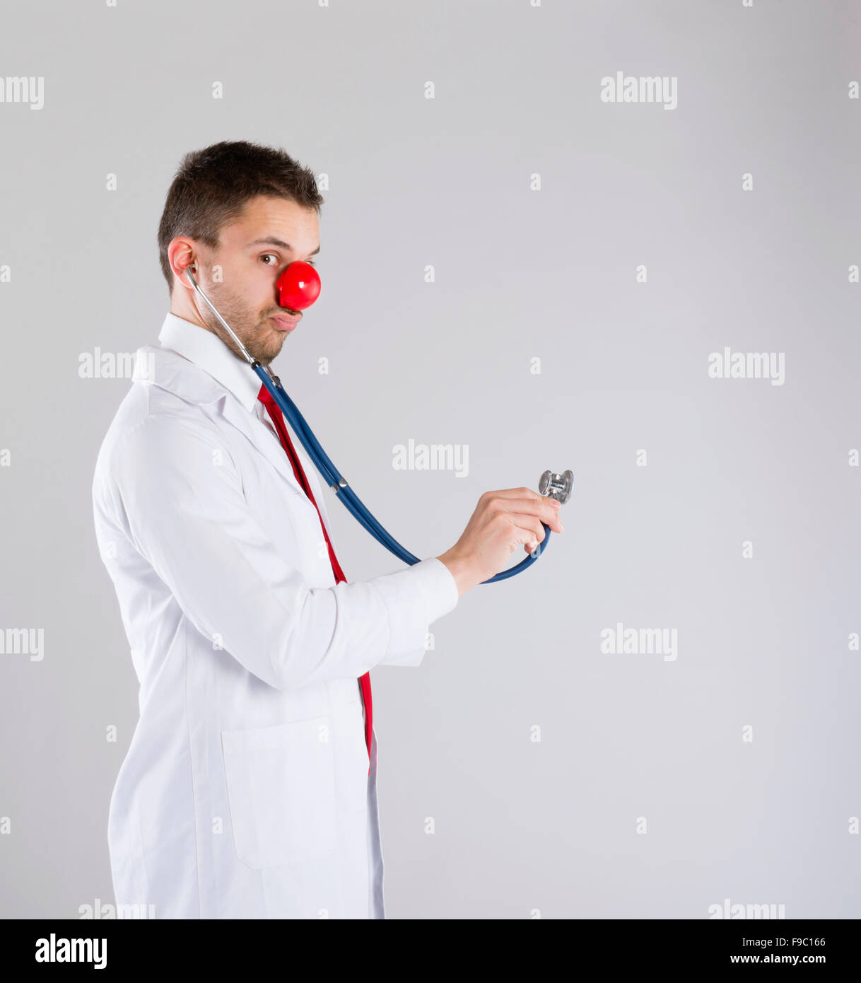 Portrait of funny doctor with red nose Stock Photo - Alamy