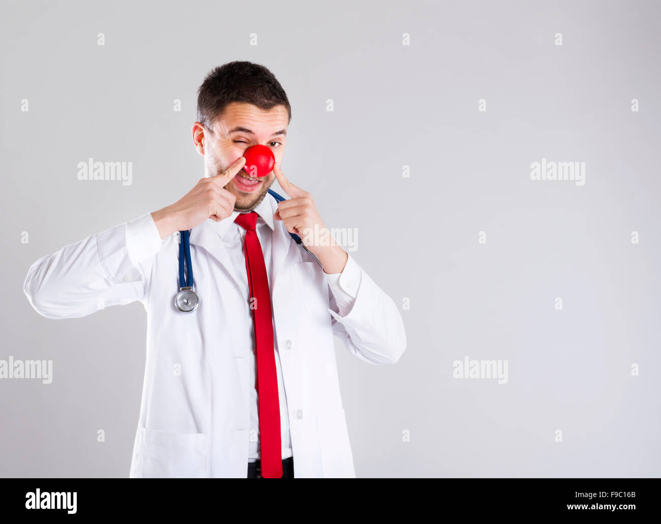 Portrait of funny doctor with red nose Stock Photo - Alamy