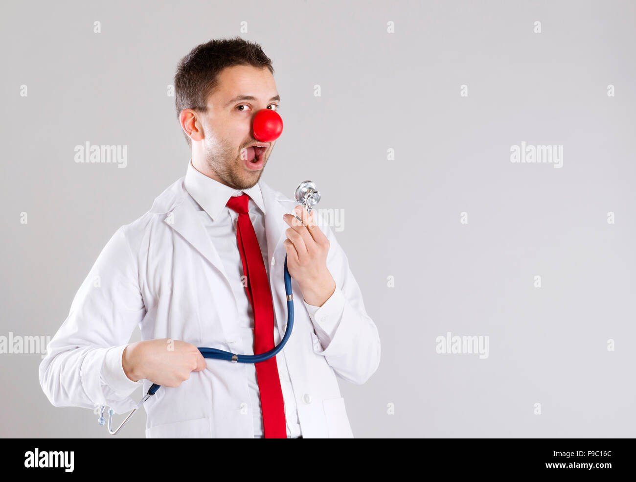 Portrait of funny doctor with red nose Stock Photo - Alamy