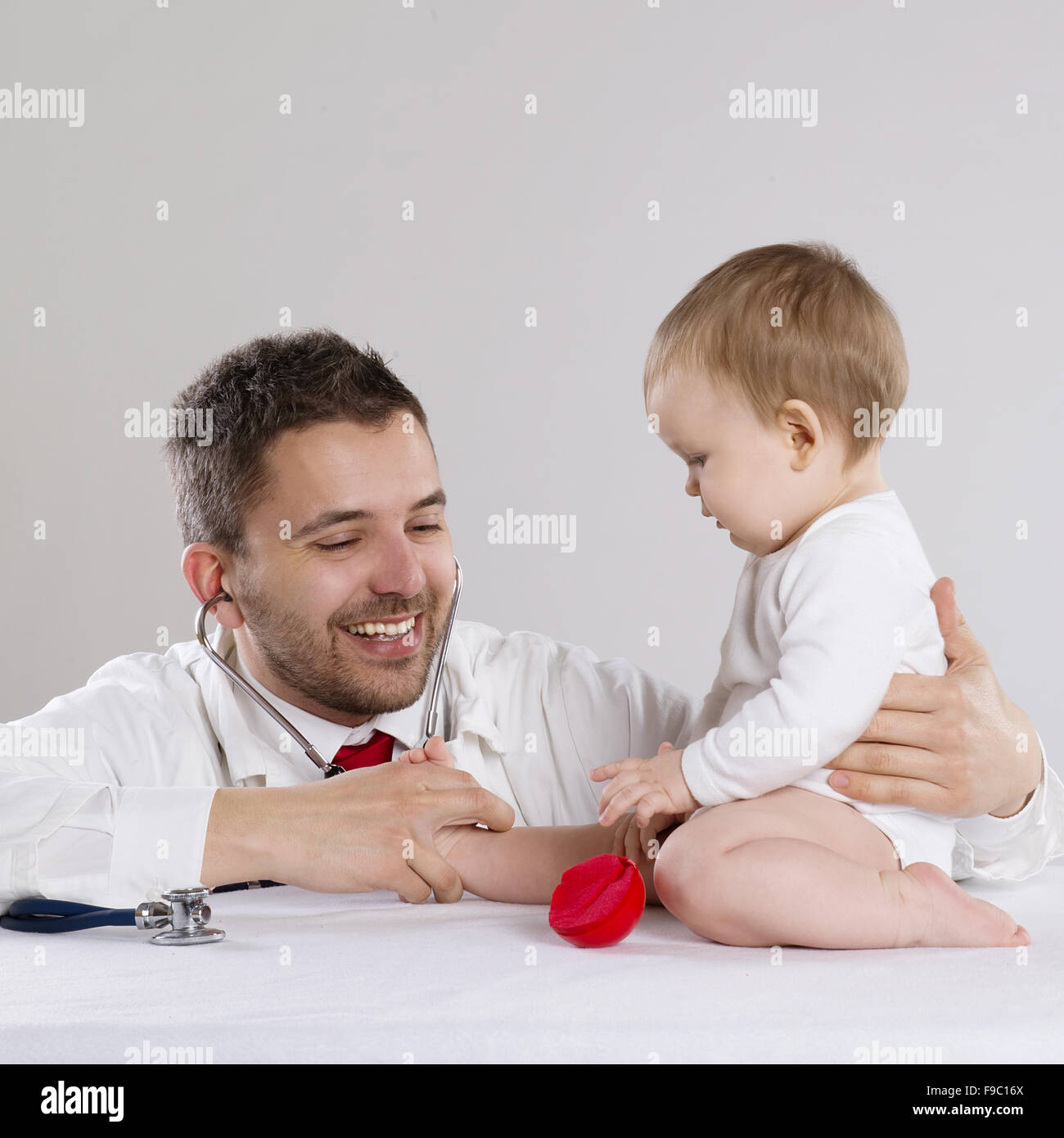 Pediatrician doctor is playing with little baby boy Stock Photo - Alamy