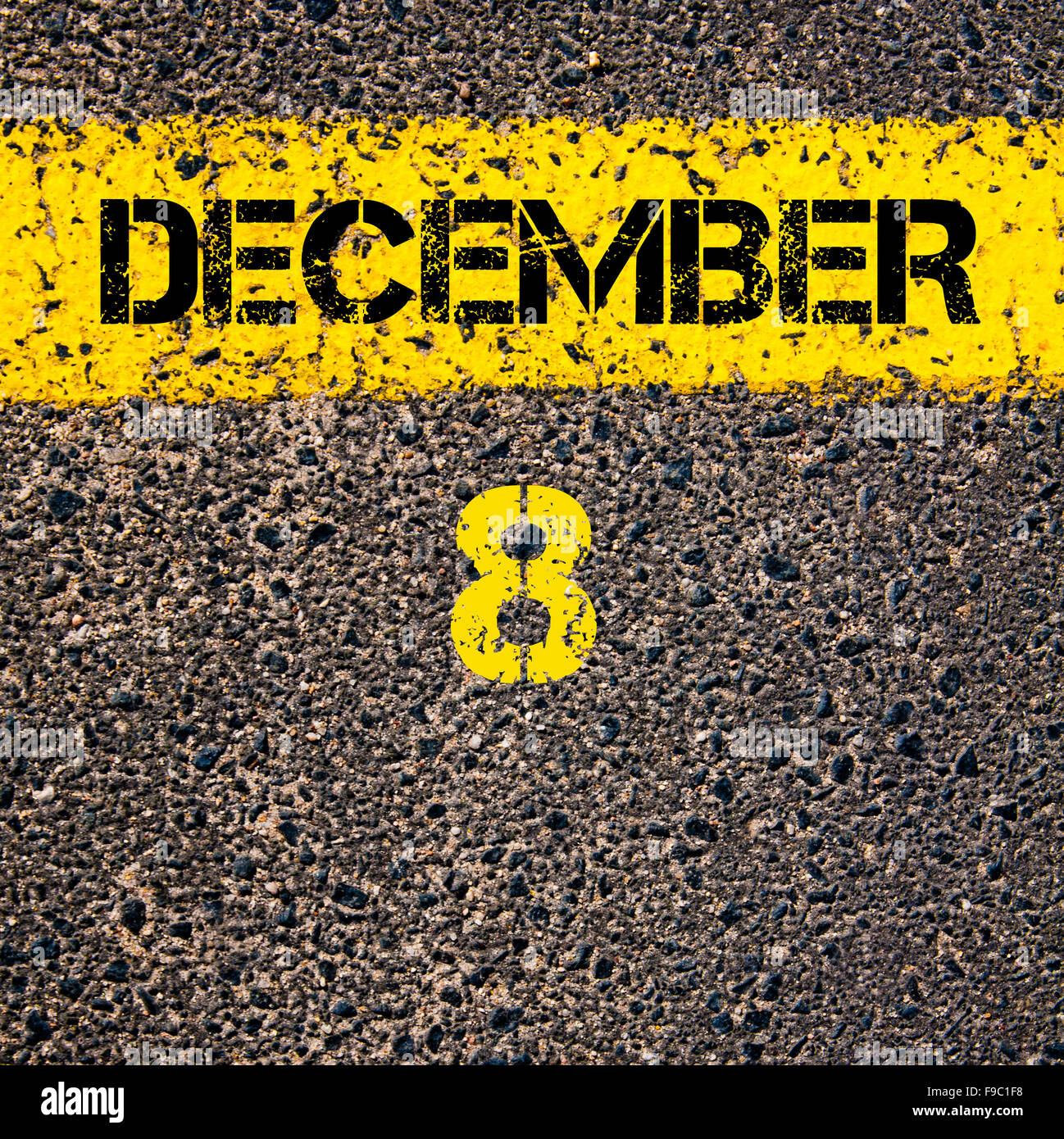 8 December calendar day written over road marking yellow paint line ...