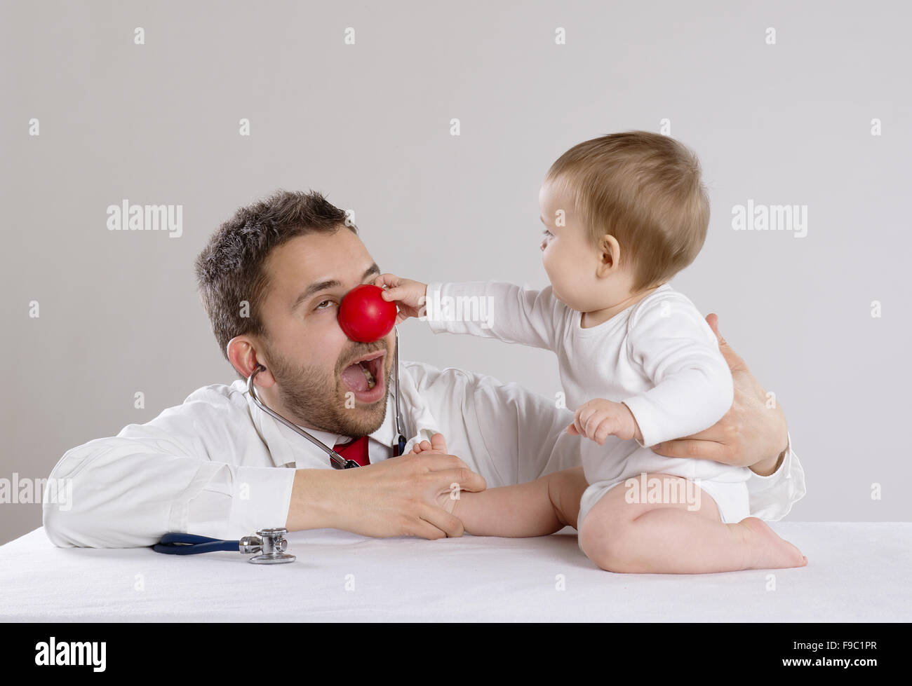 Pediatrician doctor with red nose showing baby stethoscope Stock Photo ...