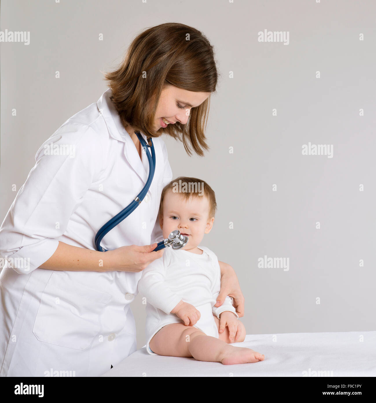 Cute baby and doctor isolated on white background Stock Photo - Alamy