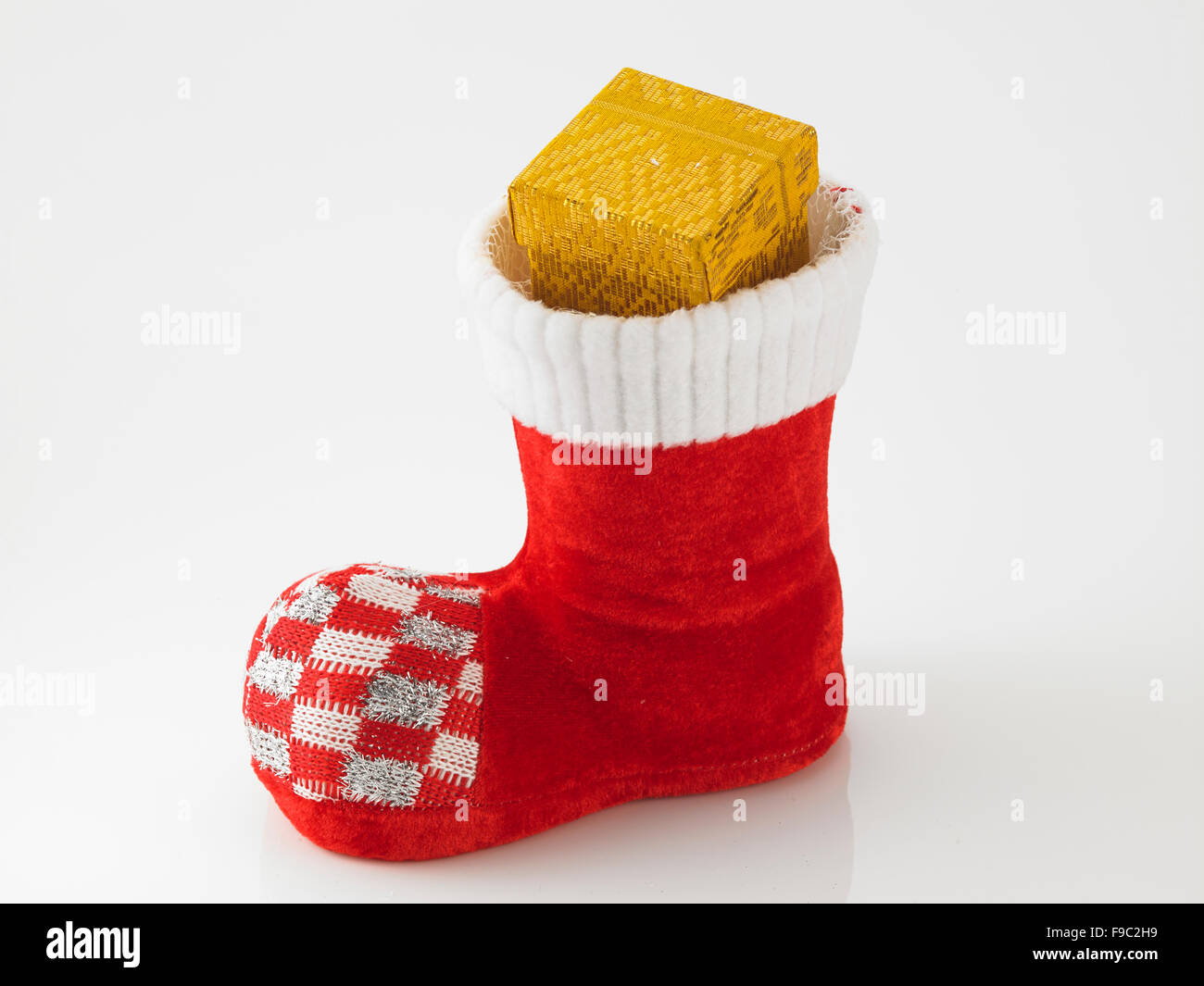 santa boot with present box on white background Stock Photo - Alamy