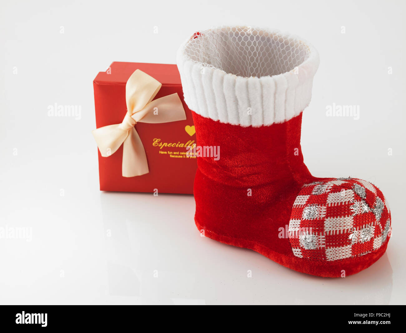 santa boot and present box on white background Stock Photo - Alamy