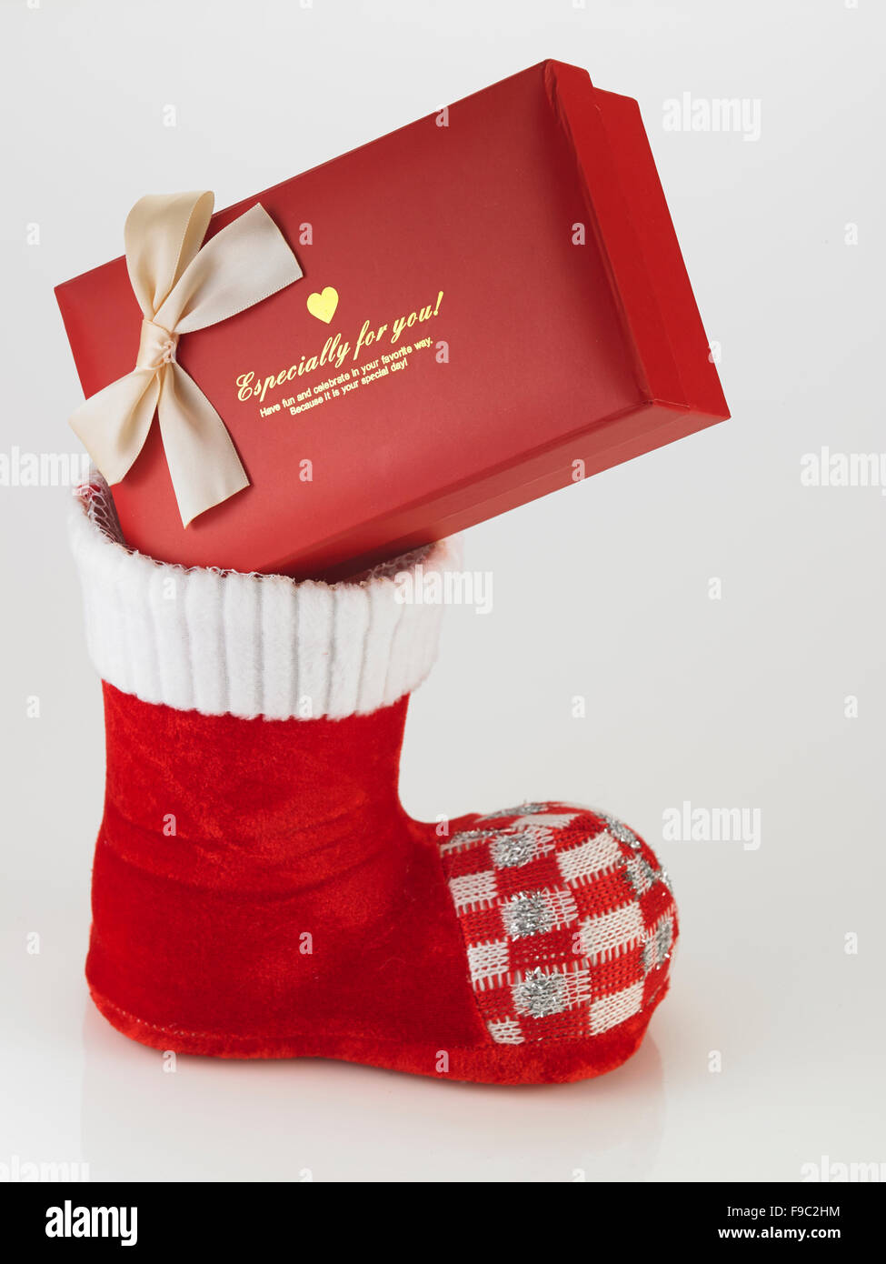 santa boot and present box on white background Stock Photo - Alamy