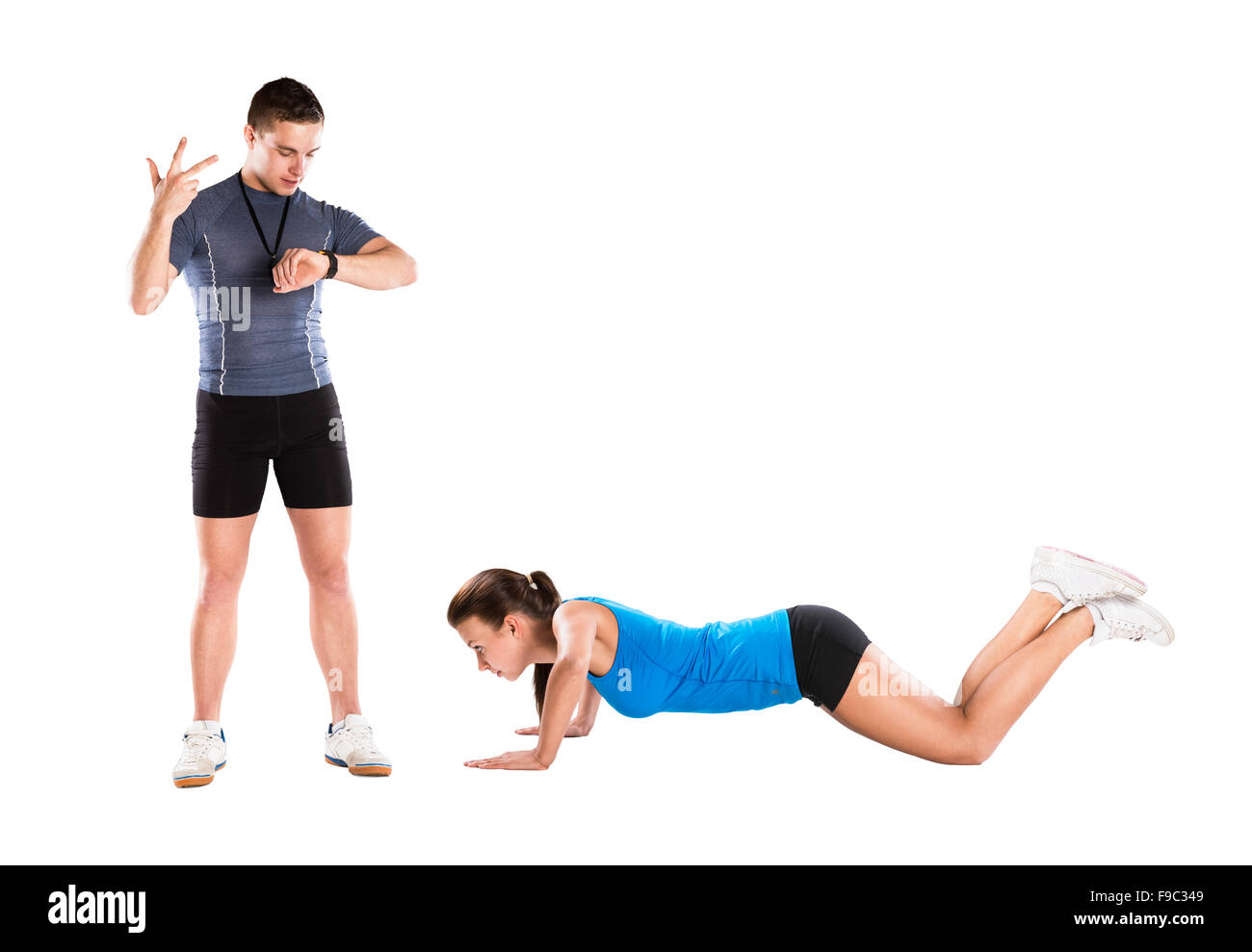 Professional fitness coach with beautiful young woman on white ...