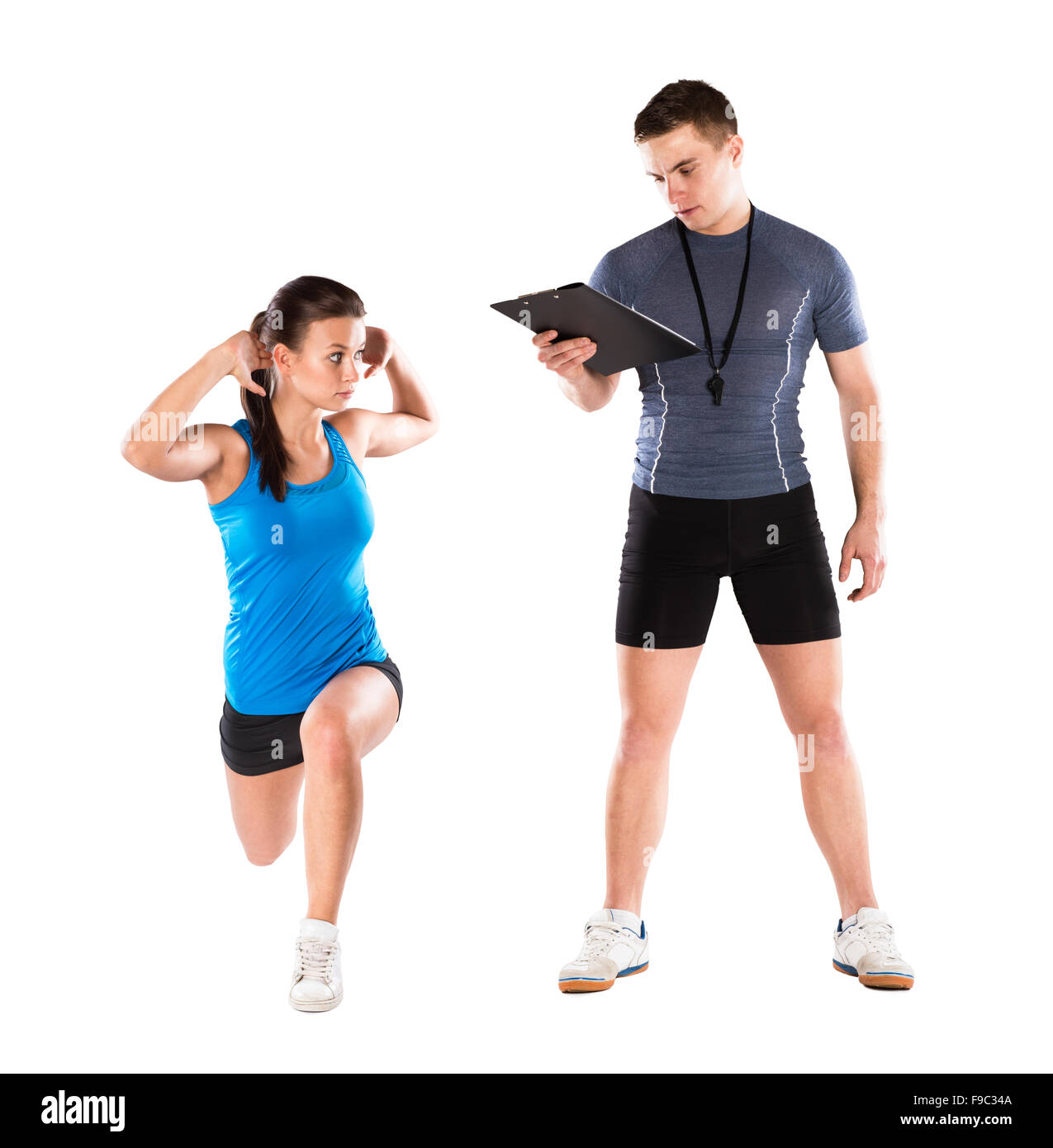 Professional fitness coach with beautiful young woman on white ...