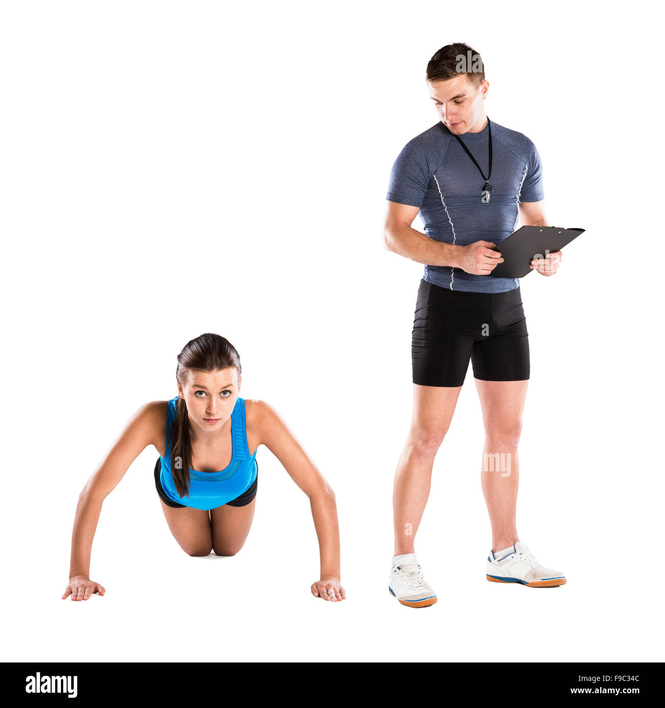 Professional fitness coach with beautiful young woman on white ...