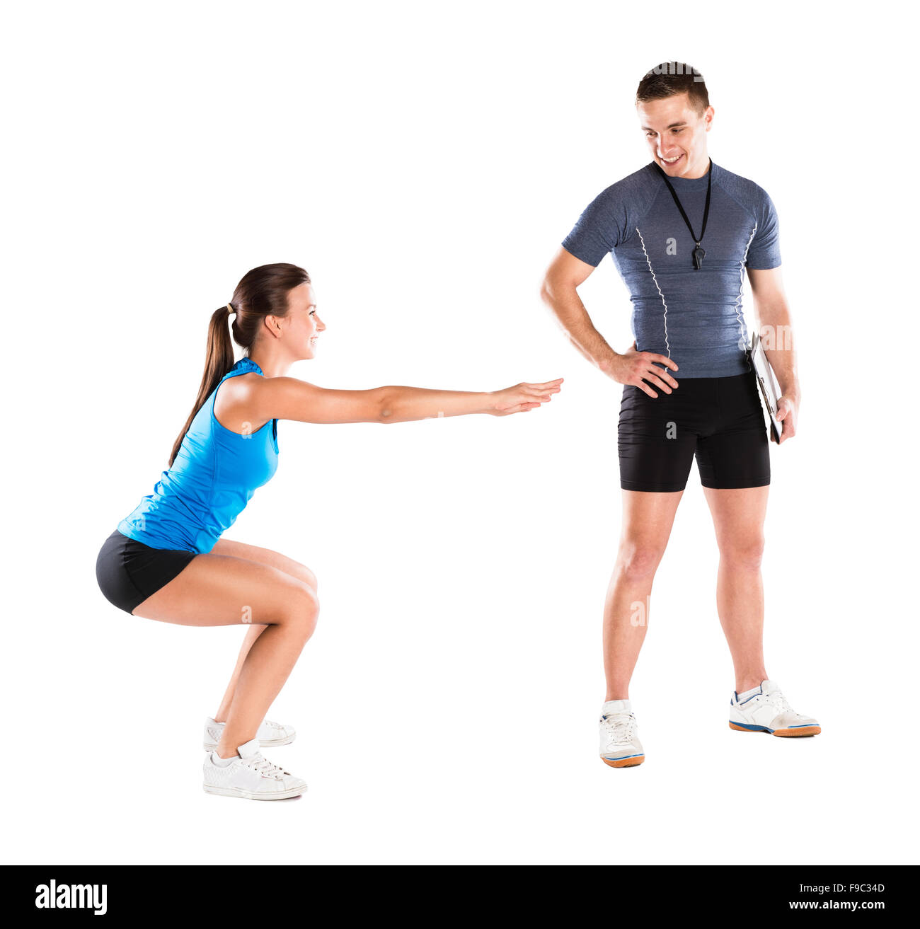 Professional fitness coach with beautiful young woman on white ...