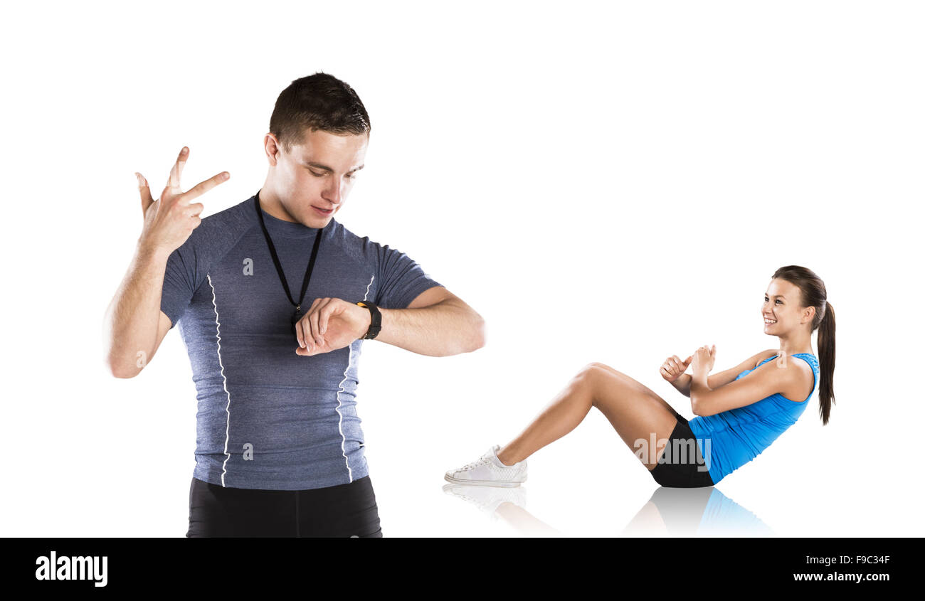 Professional fitness coach with beautiful young woman on white ...