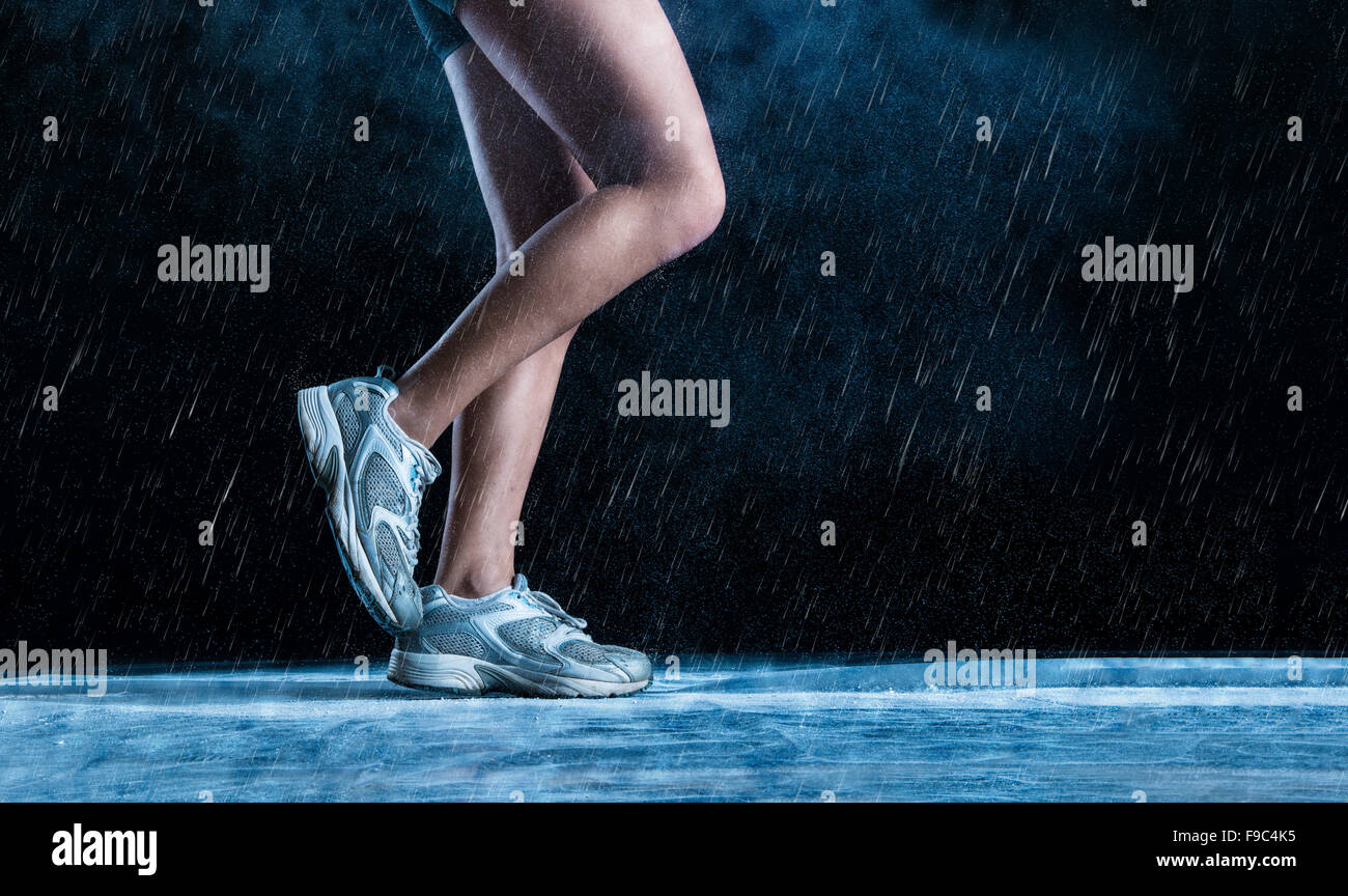 Detail of runne feet running in misty dark Stock Photo - Alamy