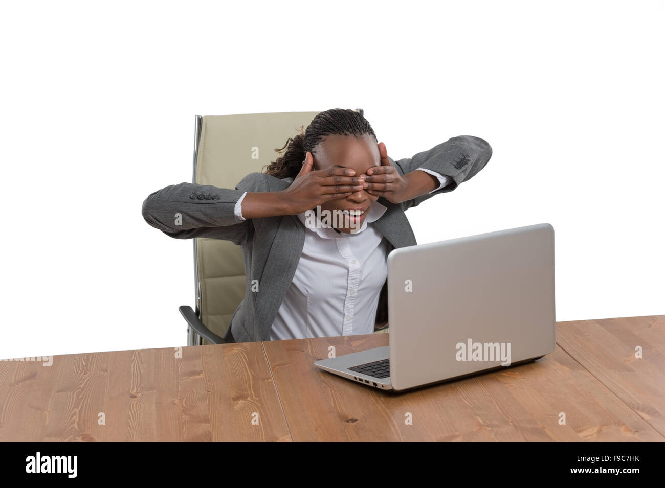 African business woman sitting at her desk and working with laptop ...