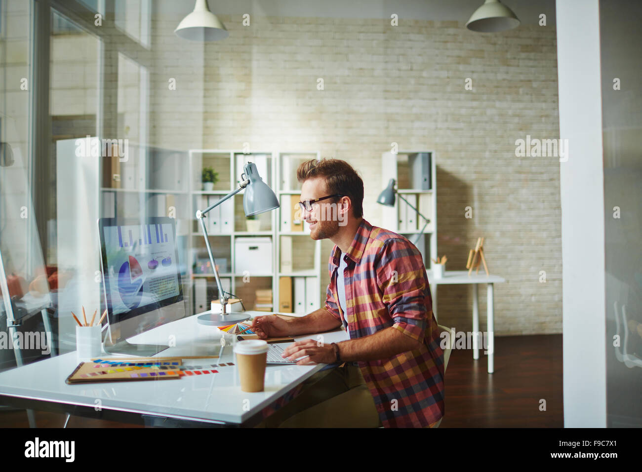 Male designer using computer at office Stock Photo - Alamy