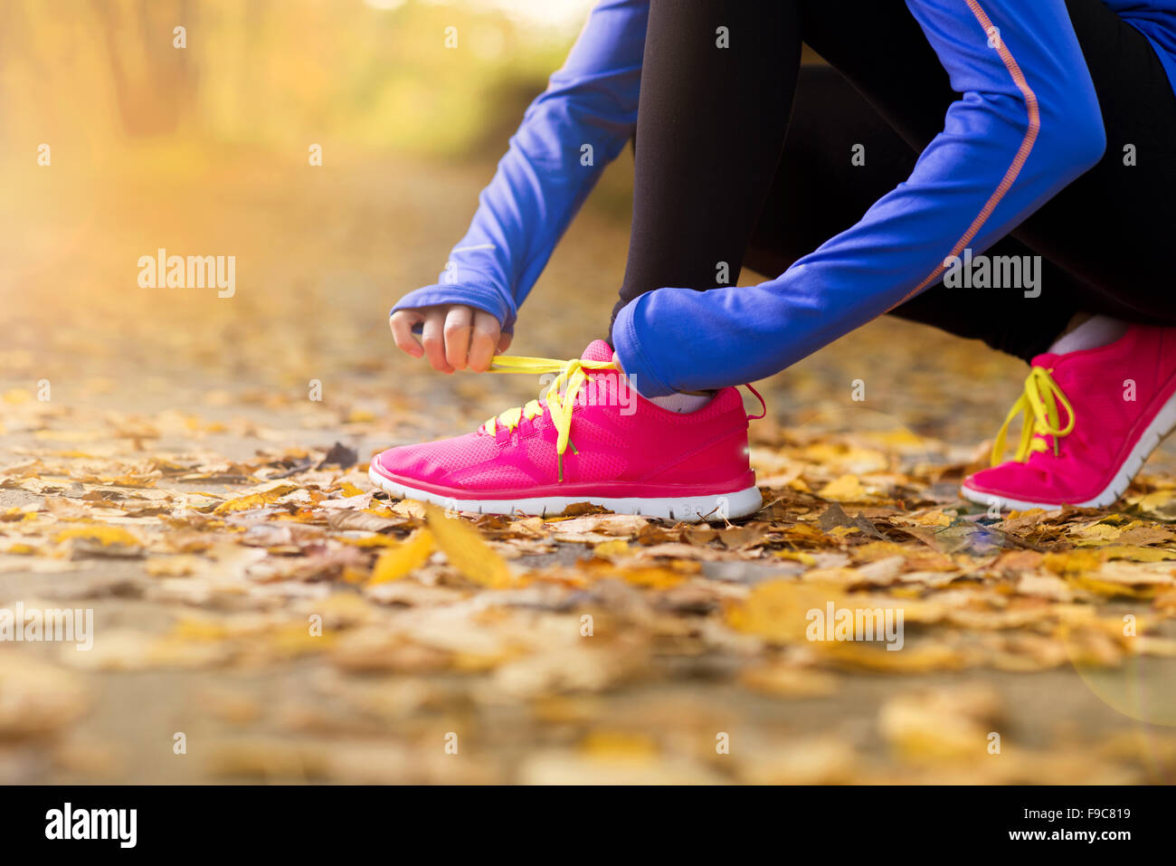 Close up of feet of a runner running in autumn leaves training exercise ...