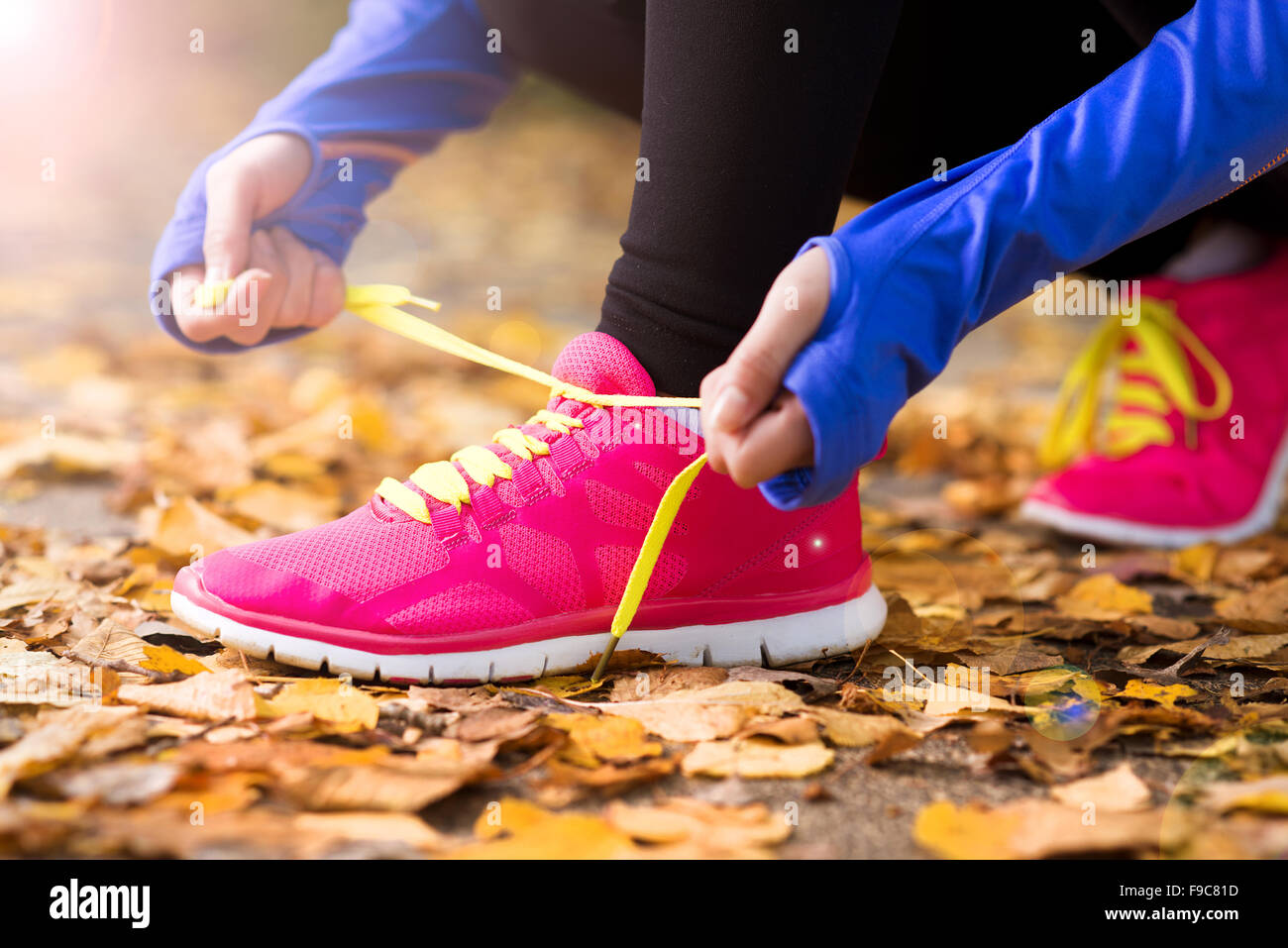 Close up of feet of a runner running in autumn leaves training exercise ...