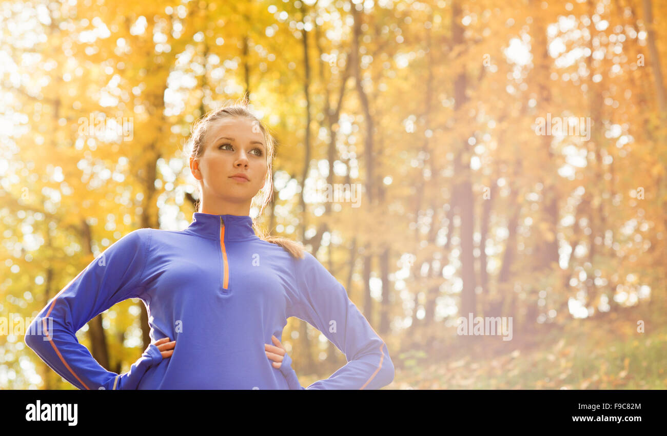 Bautiful running woman jogging in autumn nature Stock Photo - Alamy