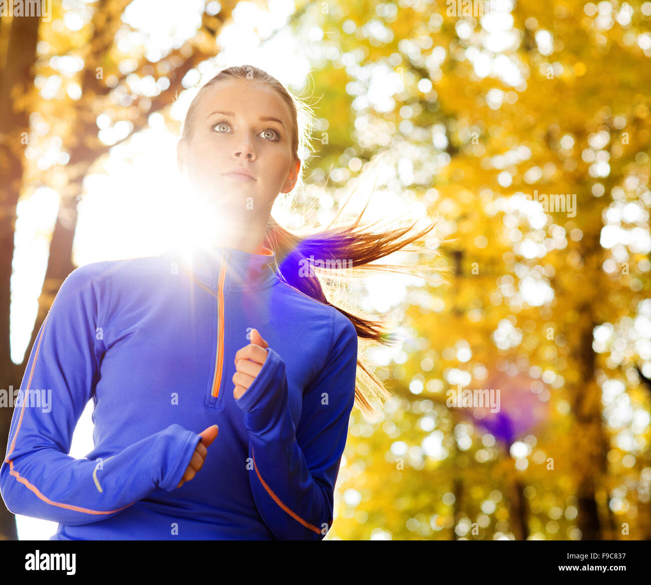 Bautiful running woman jogging in autumn nature Stock Photo - Alamy