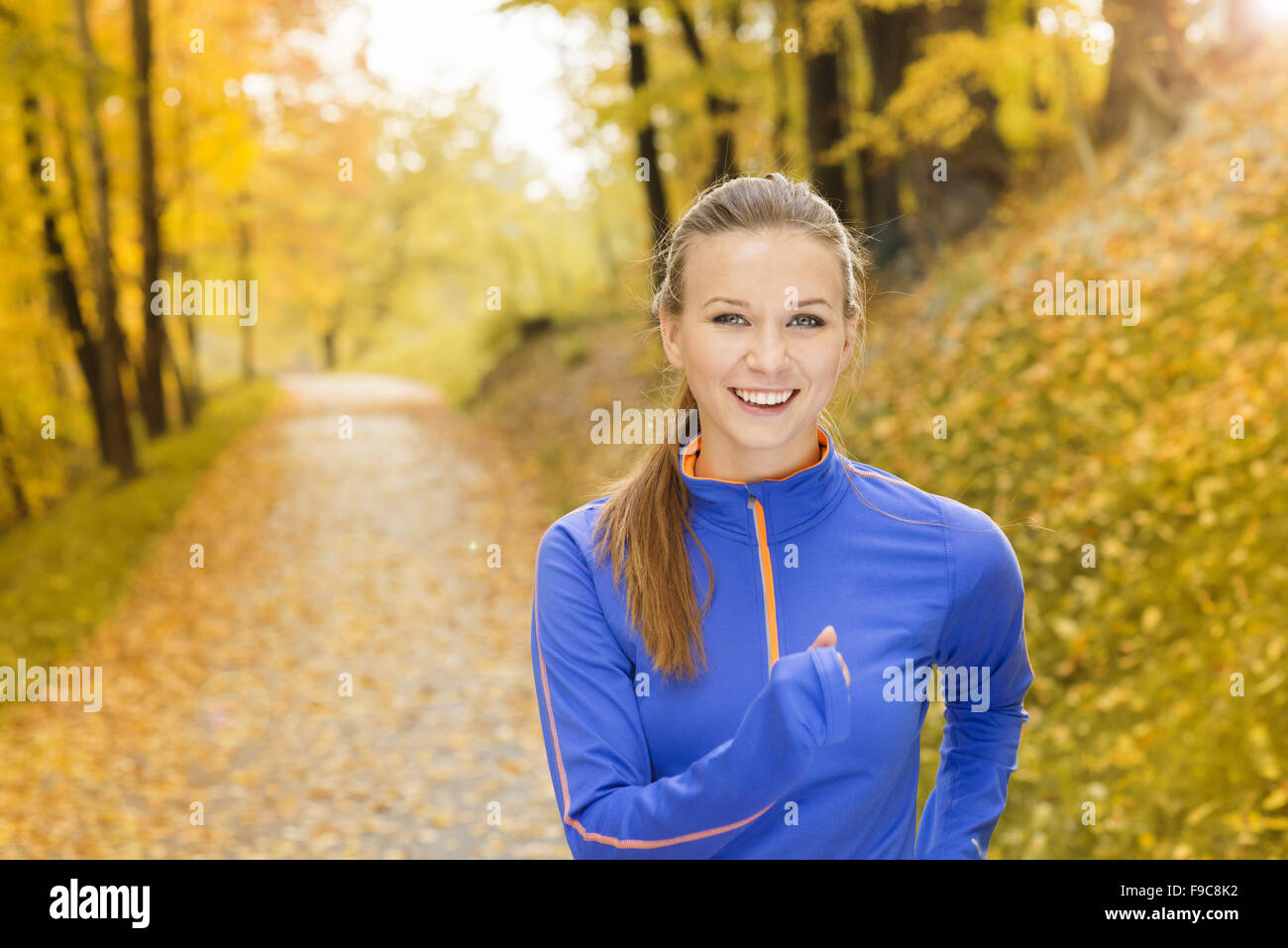 Bautiful running woman jogging in autumn nature Stock Photo - Alamy