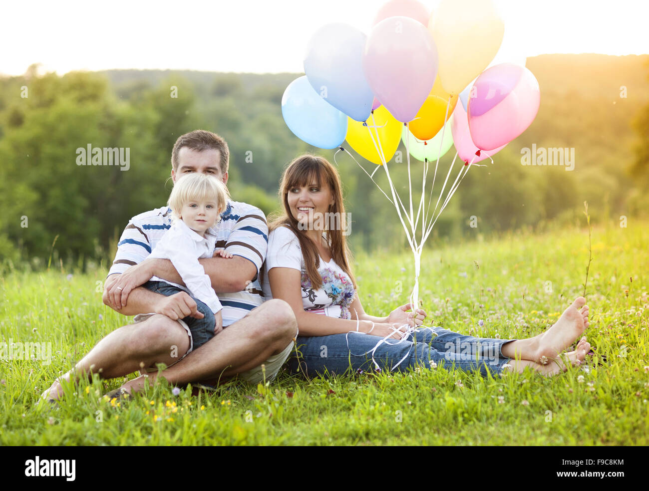 Happy young family spending time outdoor on a summer day Stock Photo ...
