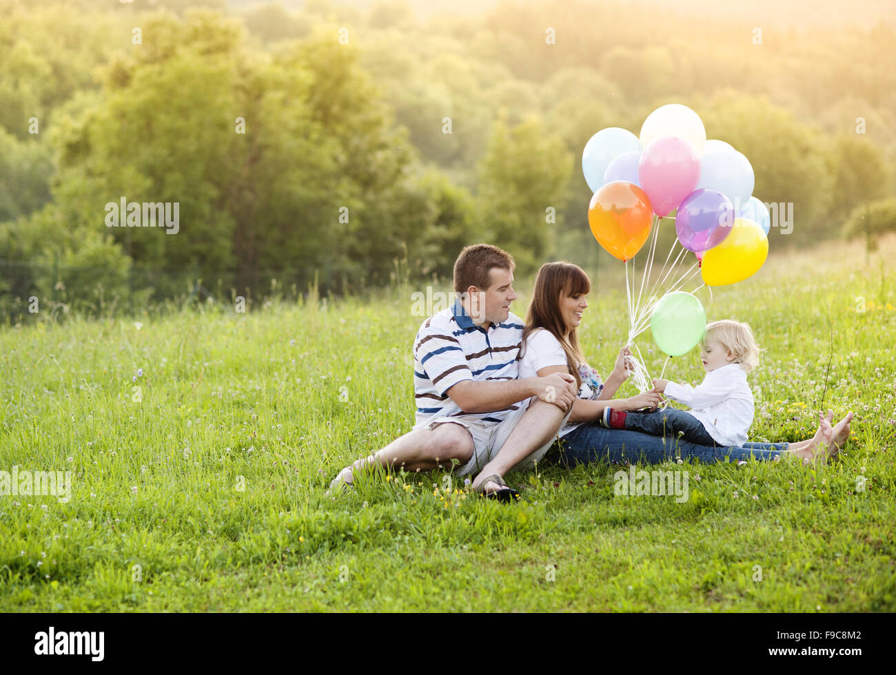 Happy young family spending time outdoor on a summer day Stock Photo ...