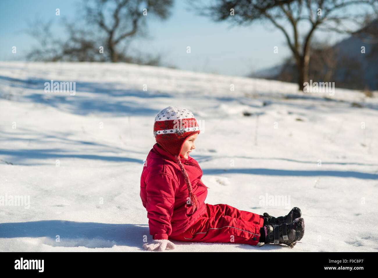 Little girl is playing outside in cold winter Stock Photo - Alamy