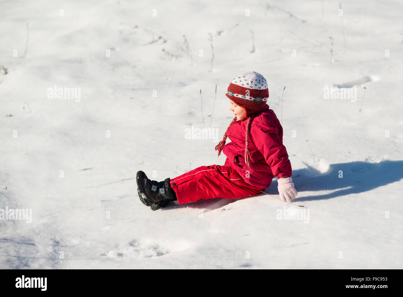 Little girl is playing outside in cold winter Stock Photo - Alamy
