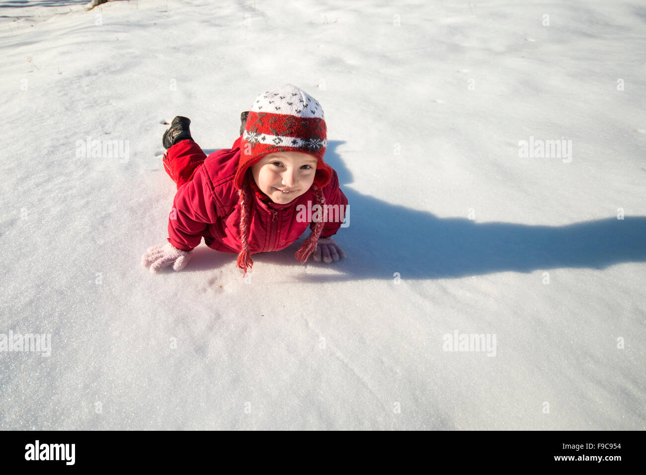 Little girl is playing outside in cold winter Stock Photo - Alamy