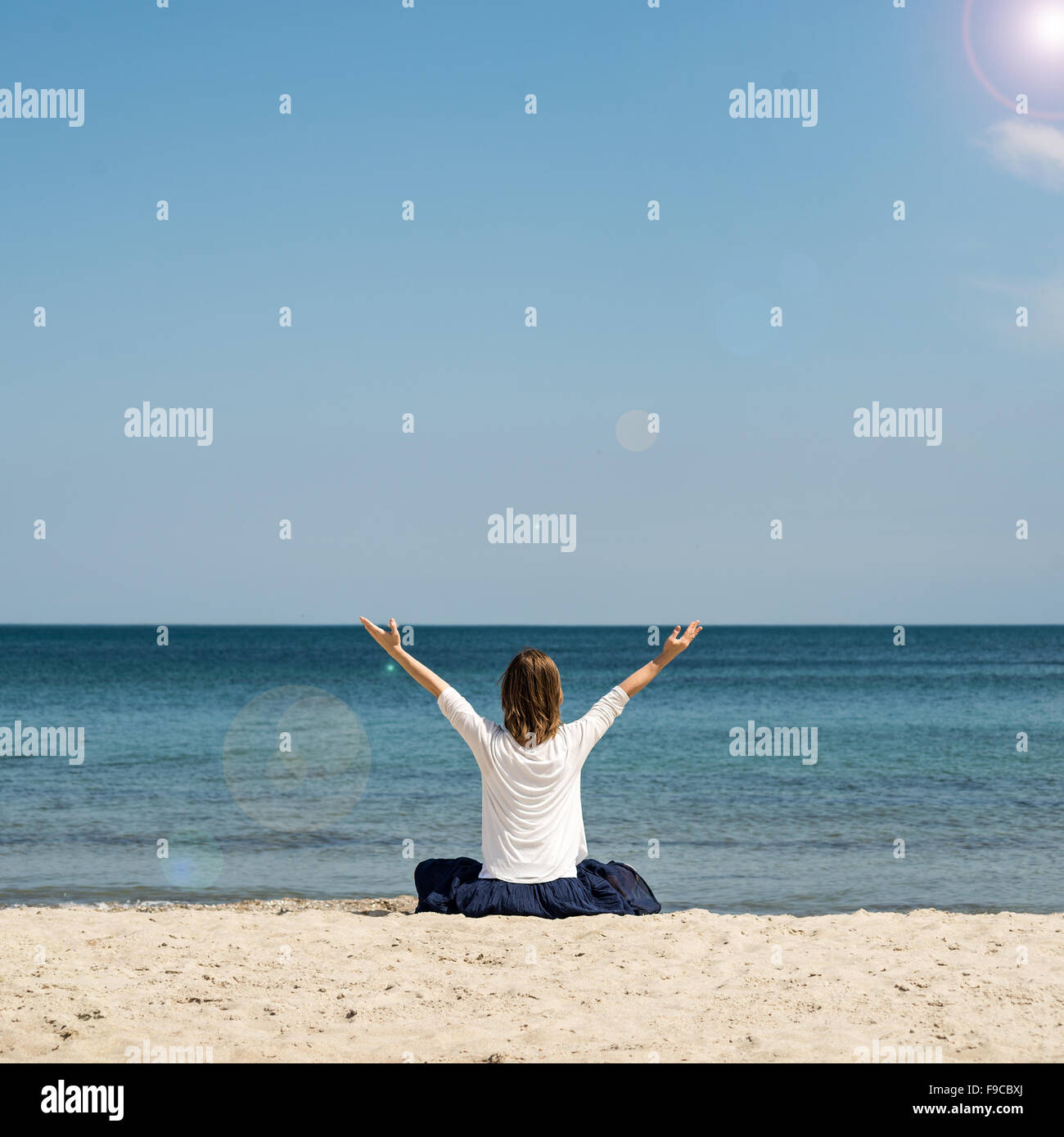 Woman meditating at the sea Stock Photo - Alamy
