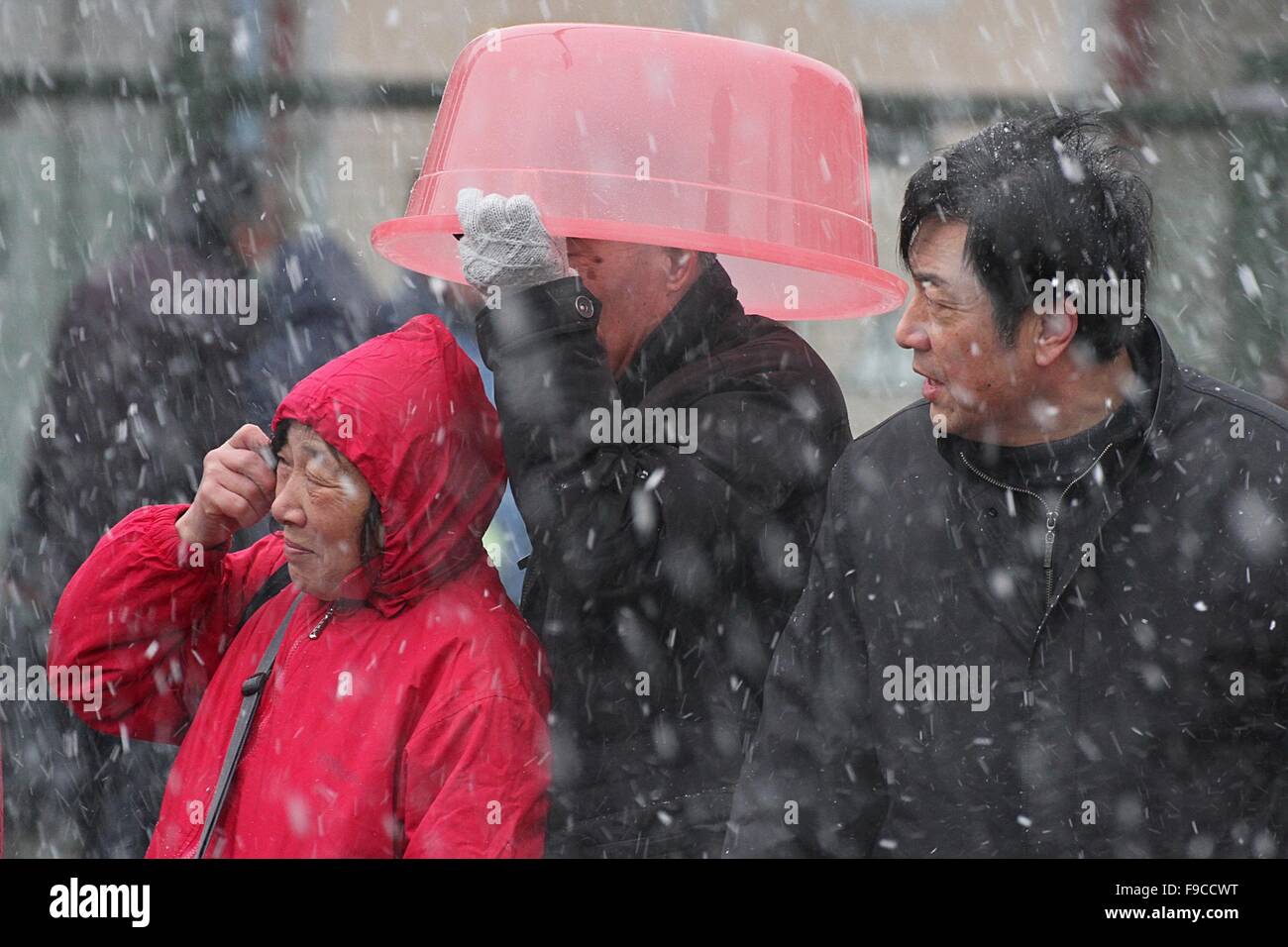 Yantai, China's Shandong Province. 16th Dec, 2015. People walk in heavy ...