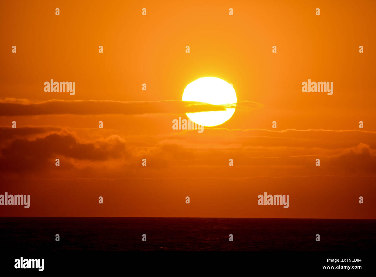 The Sun Setting in the Sea Stock Photo - Alamy