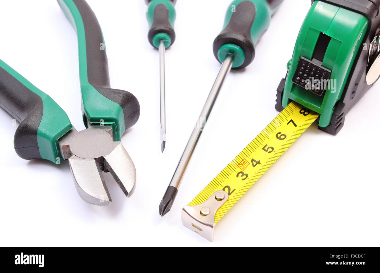 Metal pliers, electrical screwdrivers and tape measure on white ...