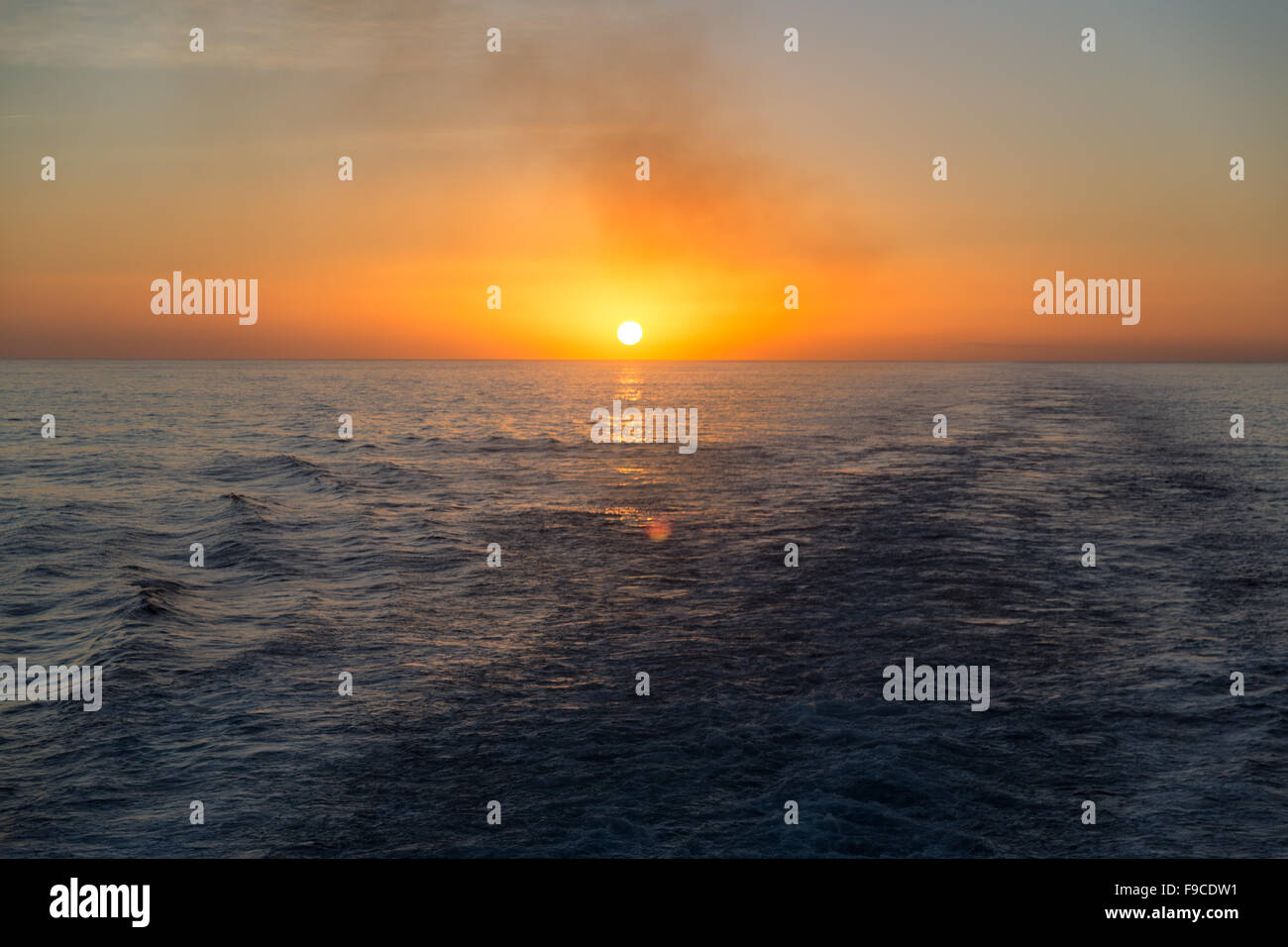 Sunset over the ocean Stock Photo - Alamy