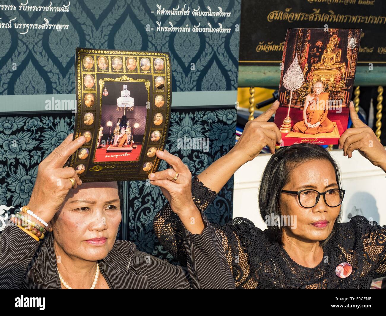Bangkok, Thailand. 16th Dec, 2015. Women hold up photos of Somdet Phra ...
