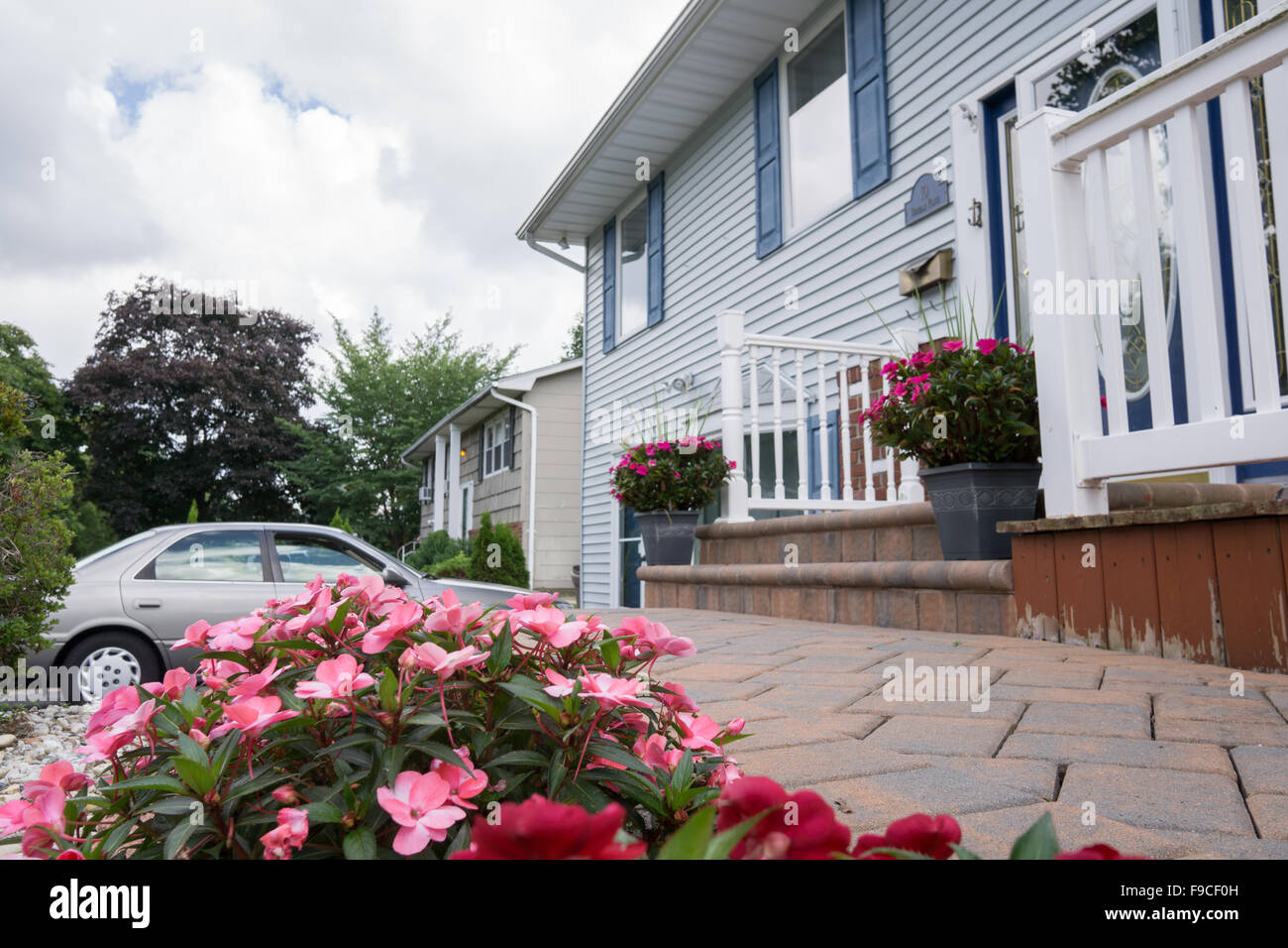 a house with a car parked on the drive way Stock Photo - Alamy