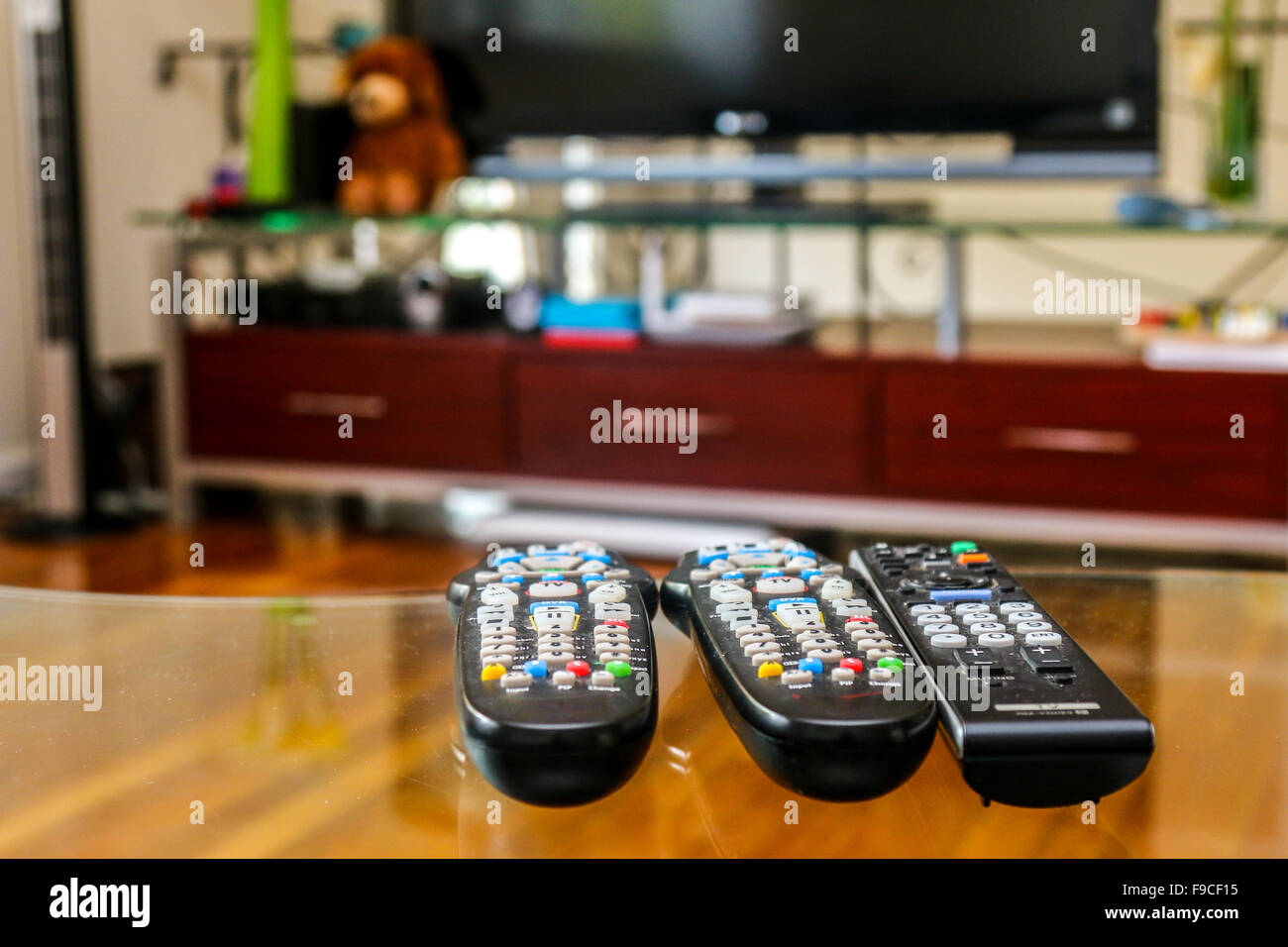 t v remote control at a glass table Stock Photo - Alamy