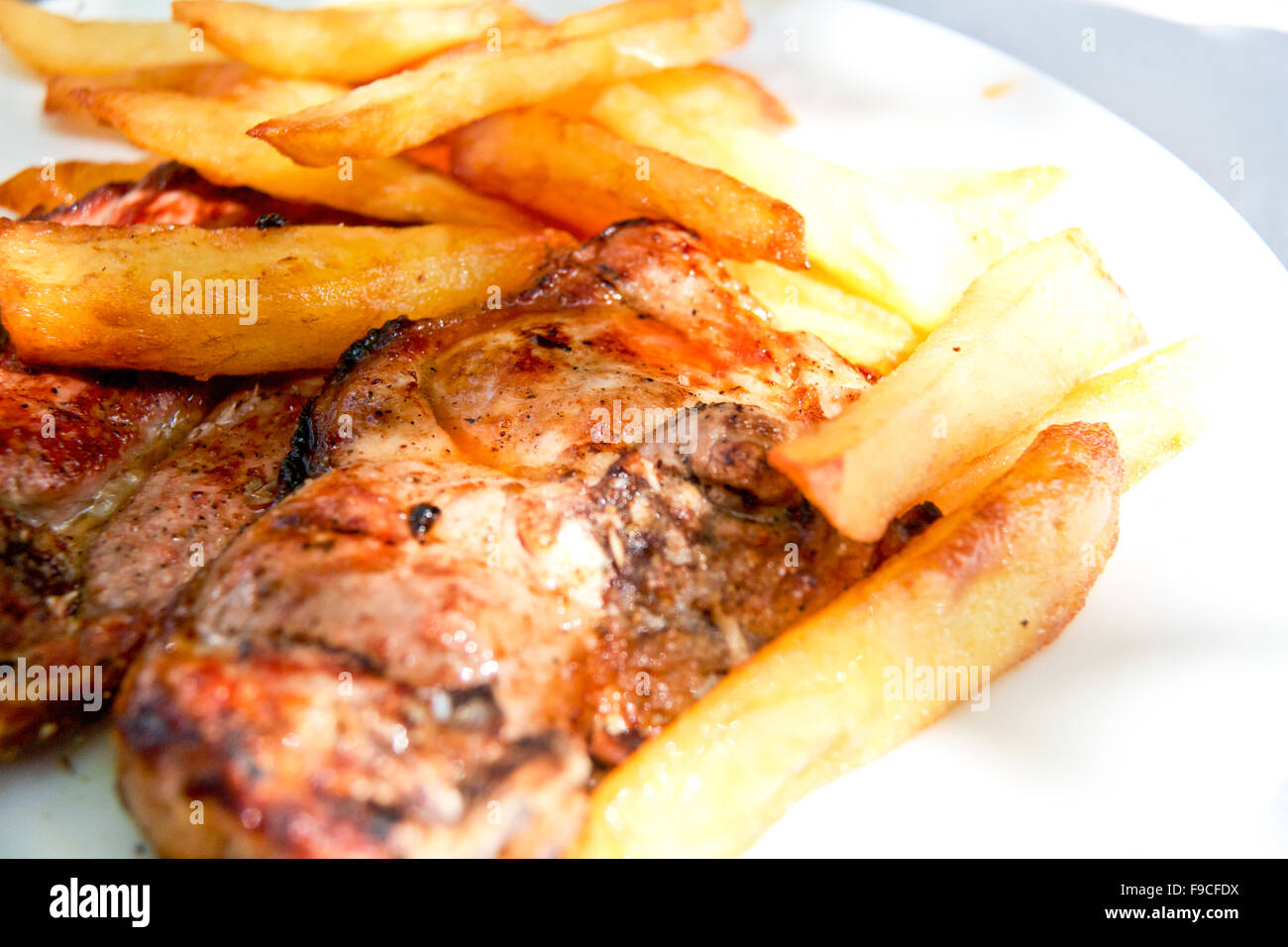 Lamp chop with french fries and tomatoes Stock Photo - Alamy