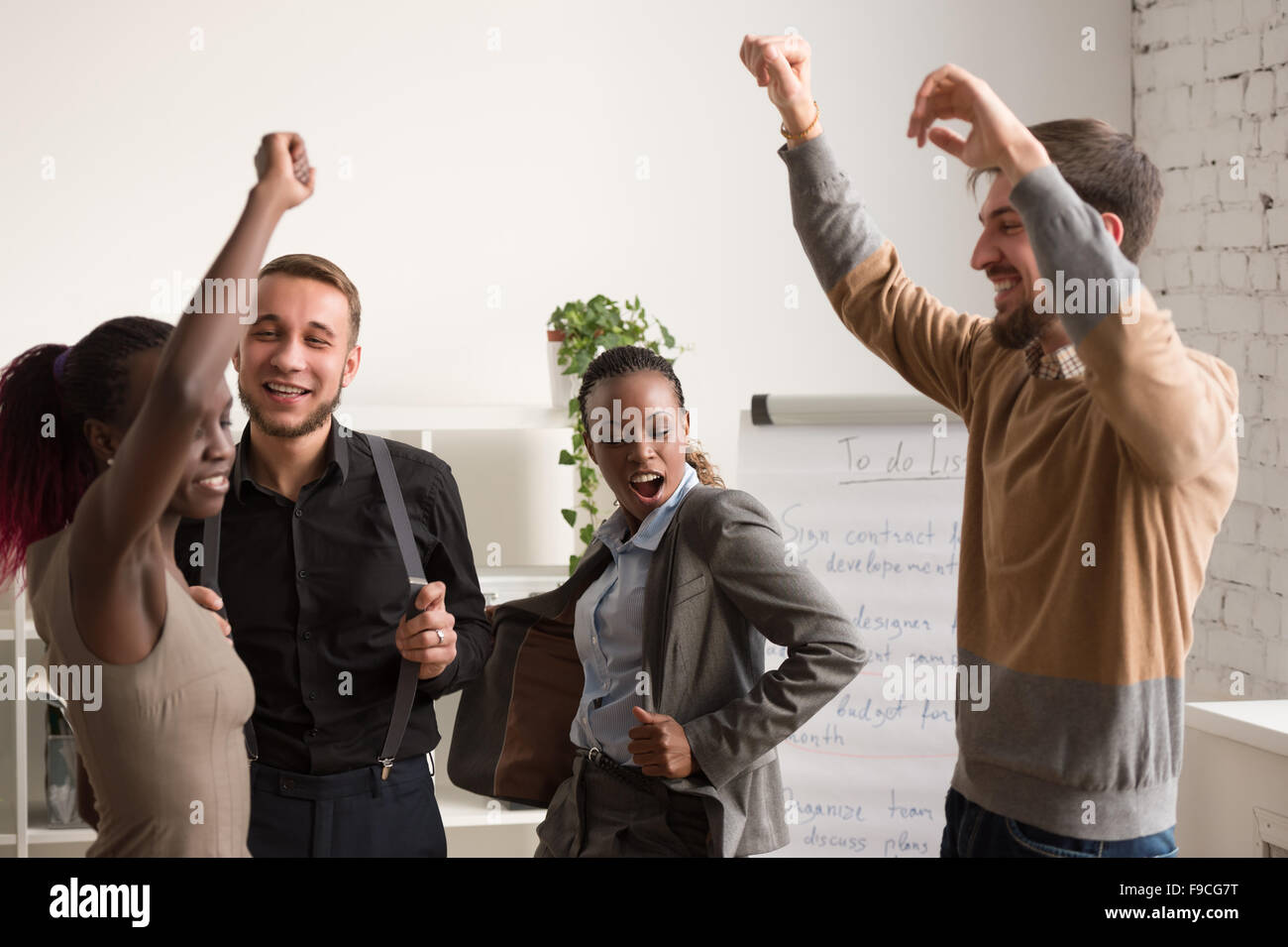 Celebrating in office colleagues dancing hi-res stock photography and ...