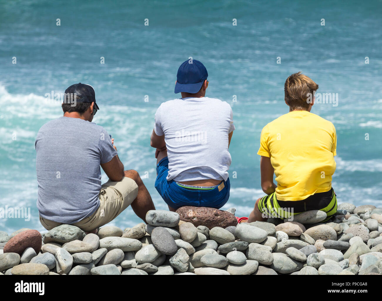 Surfers wave watching on Atlantic coast Stock Photo - Alamy
