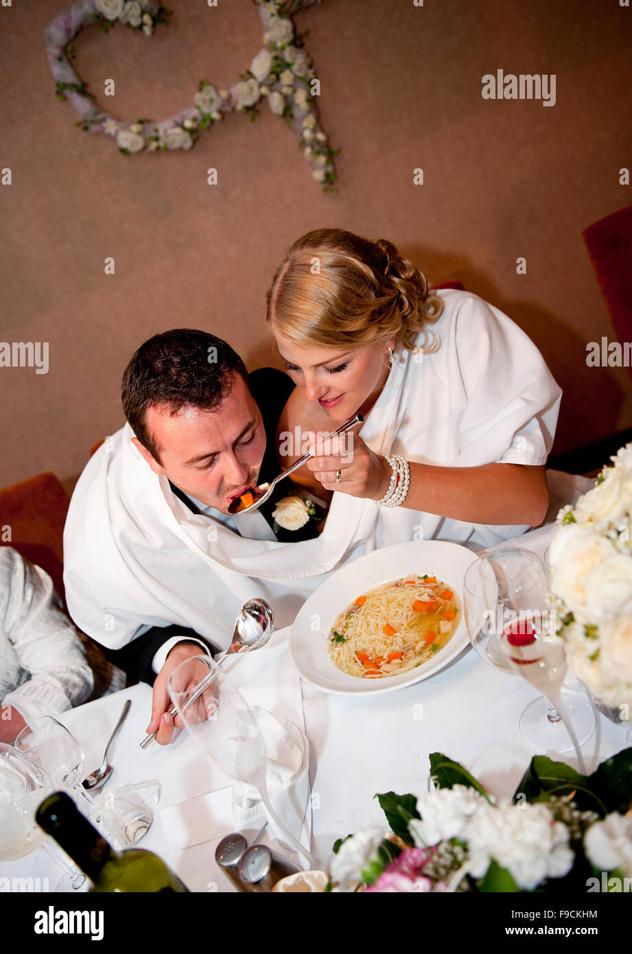 Bride and groom are eating at the wedding reception Stock Photo - Alamy