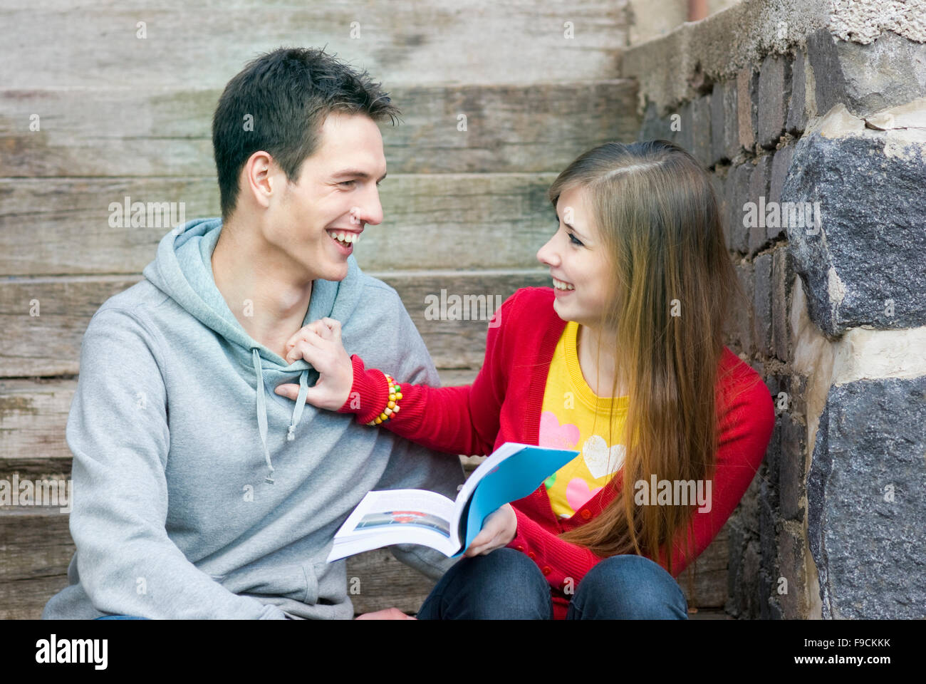 Young students are reading book together Stock Photo - Alamy
