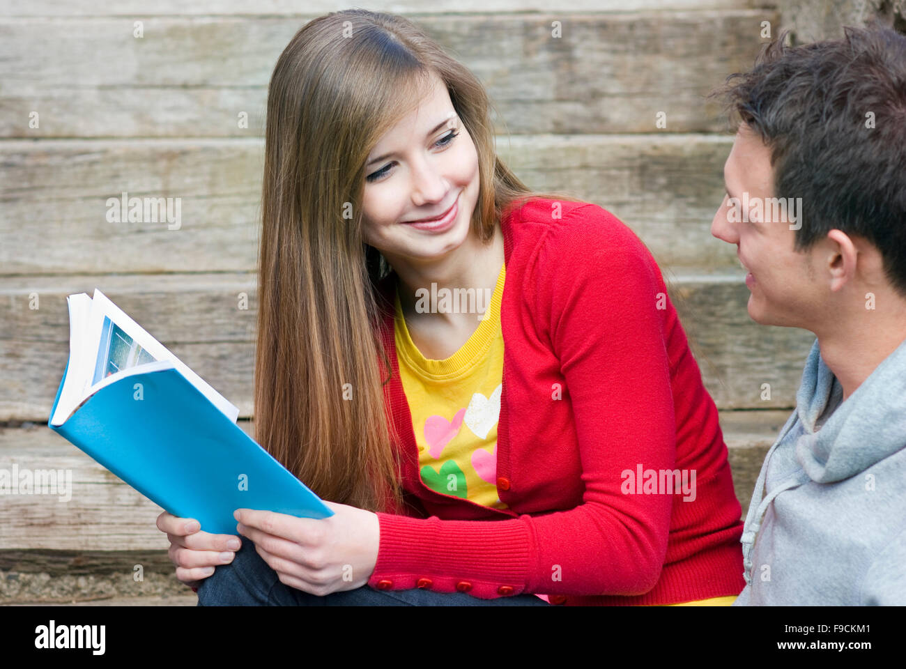 Young students are reading book together Stock Photo - Alamy