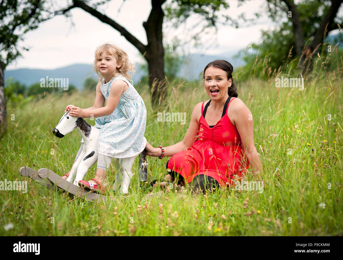 Happy family is playing together in a green meadow Stock Photo - Alamy