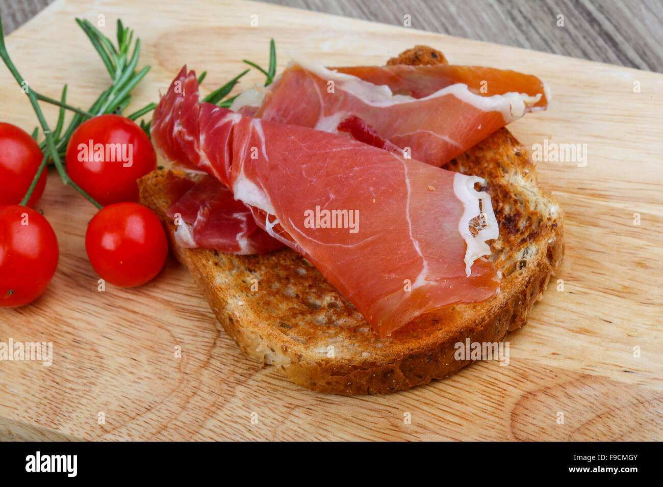 Spanish traditional snack - Jamon tapas with tomato and rosemary Stock ...